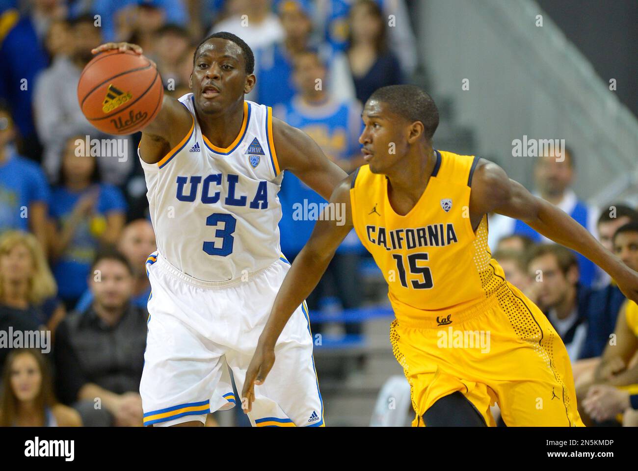 UCLA guard Jordan Adams, left, grabs a loose ball away from Cal guard ...