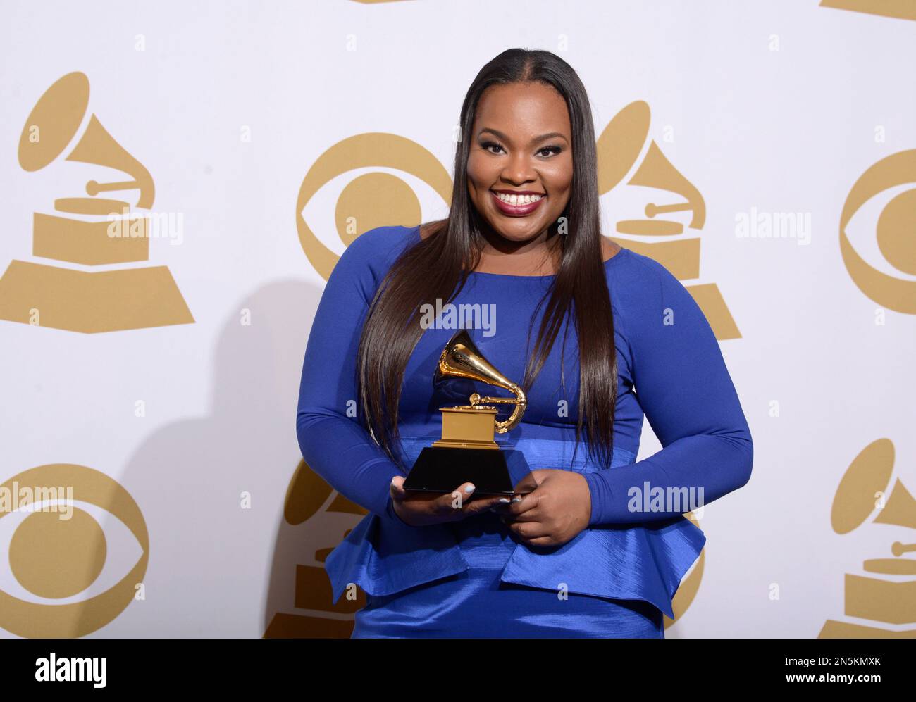 Tasha Cobbs poses in the press room with the award for best gospel/contemporary christian music ...