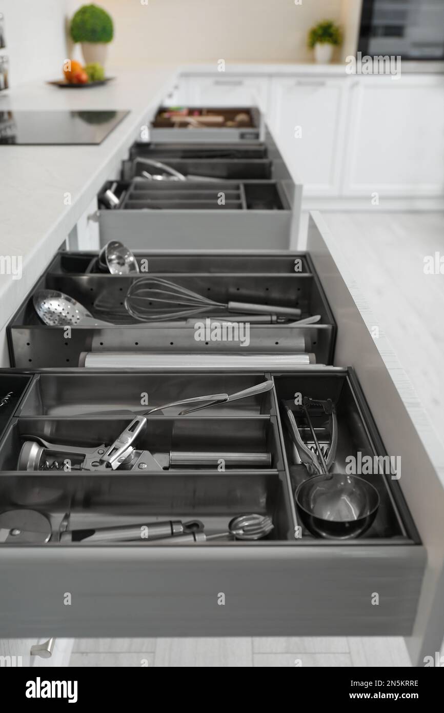 Open drawers with different utensils in kitchen Stock Photo - Alamy