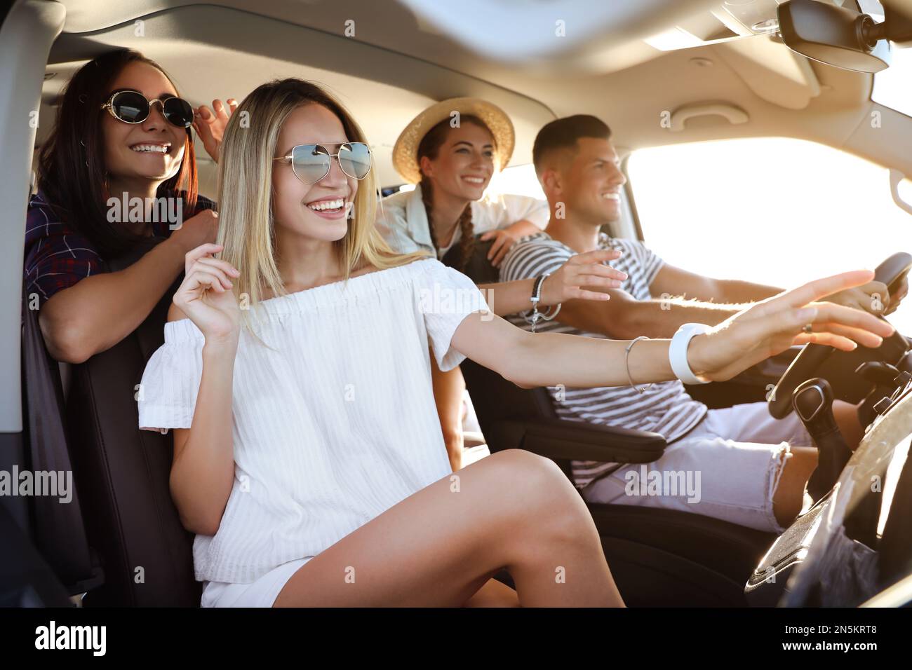 Happy friends together in car on road trip Stock Photo - Alamy