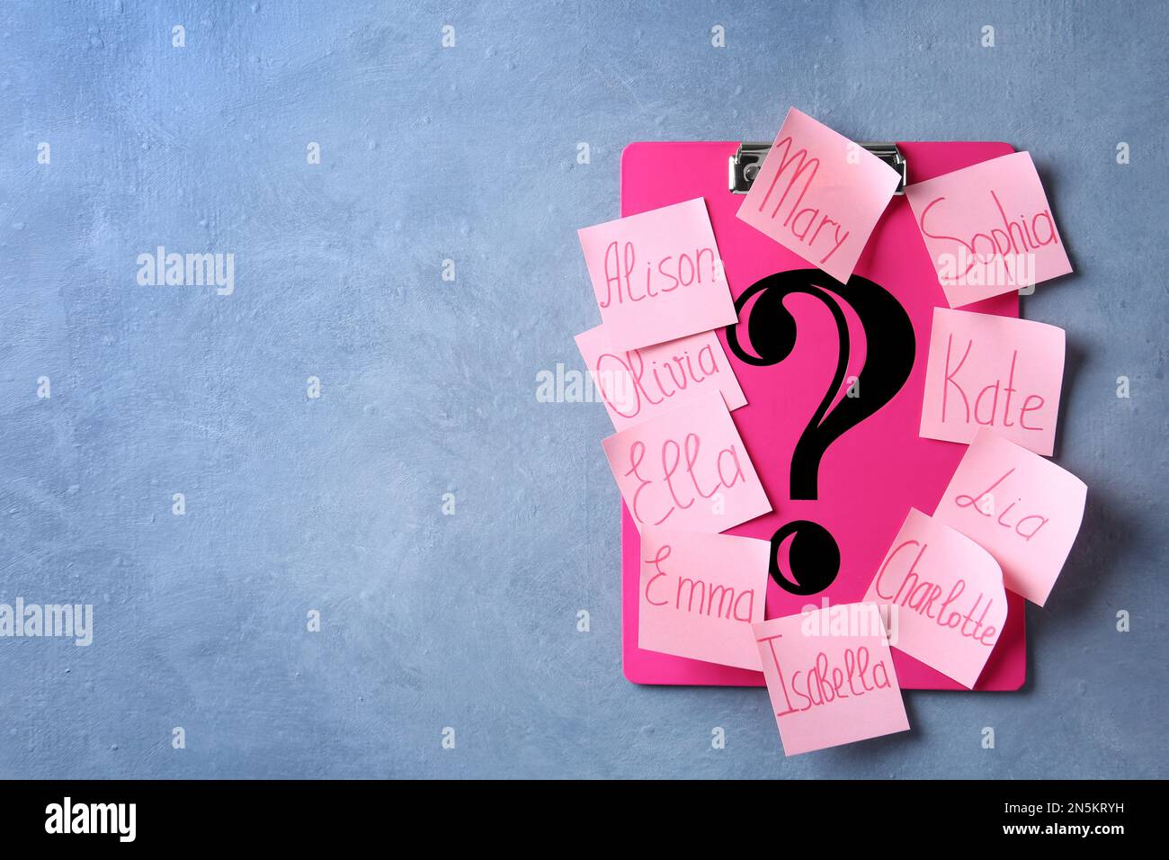 Question mark and paper notes with different baby names on blue ...
