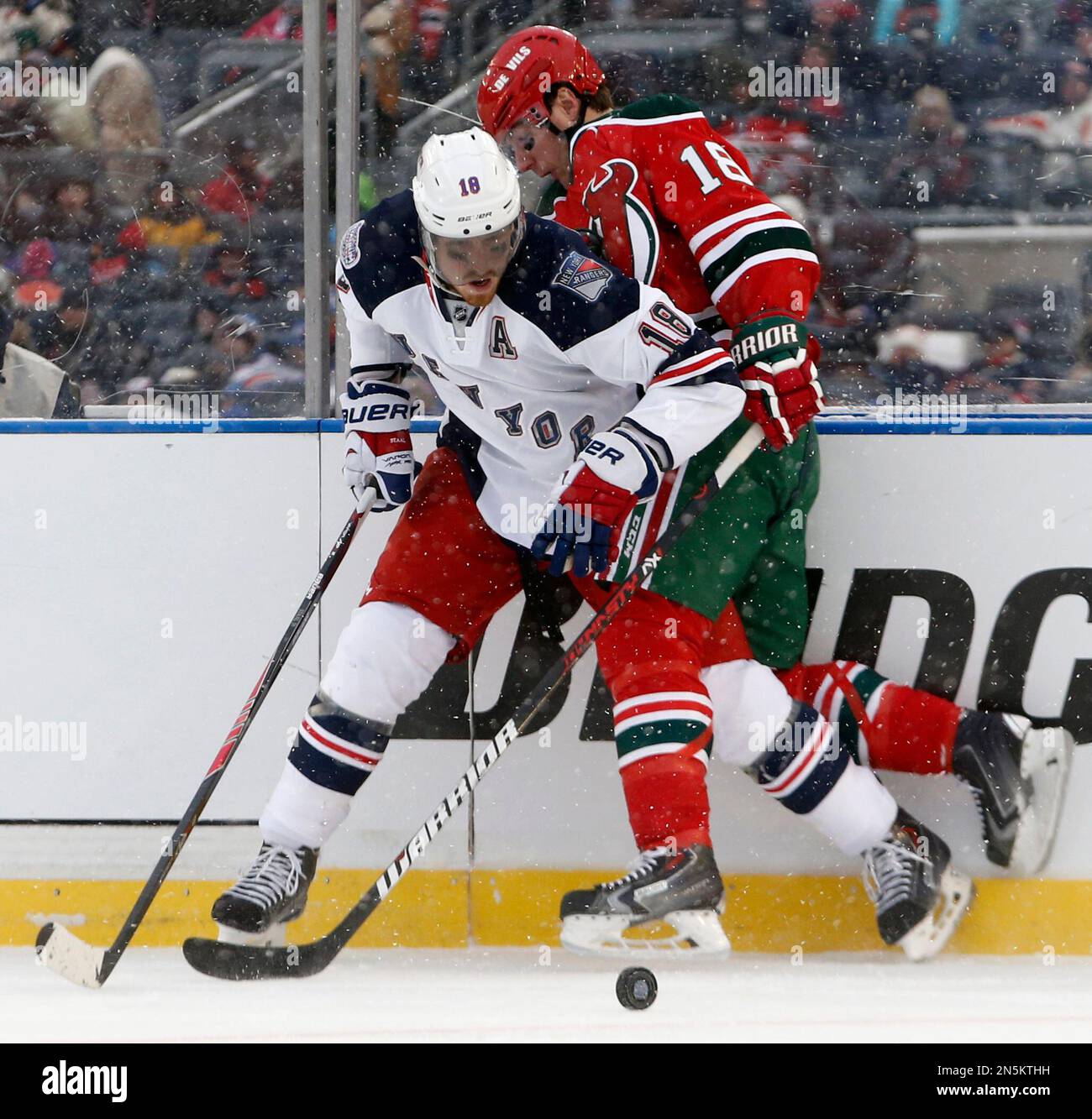 New York Rangers defenseman Marc Staal (18) checks New Jersey Devils ...