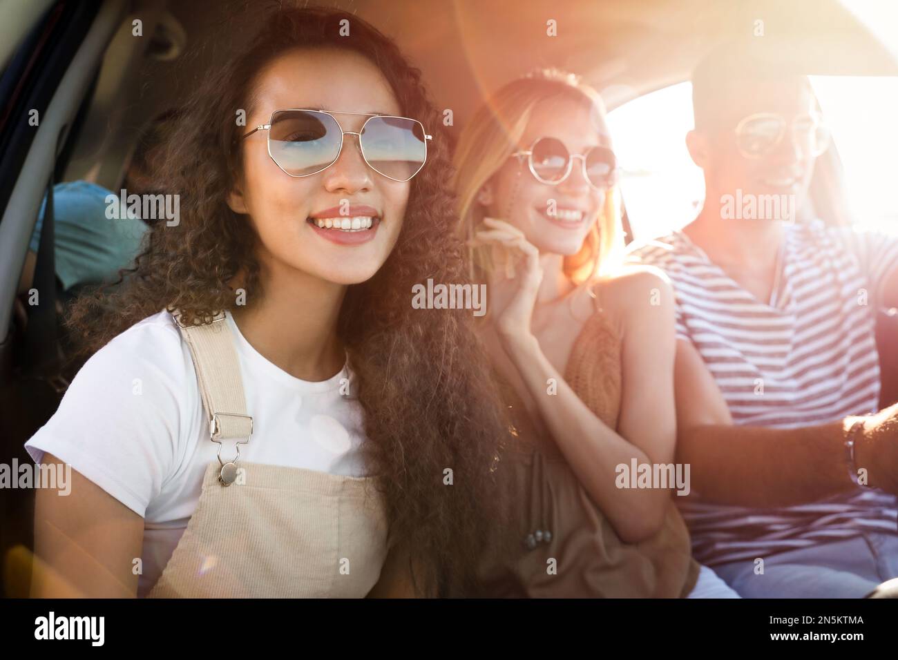 Happy friends together in car on road trip Stock Photo - Alamy