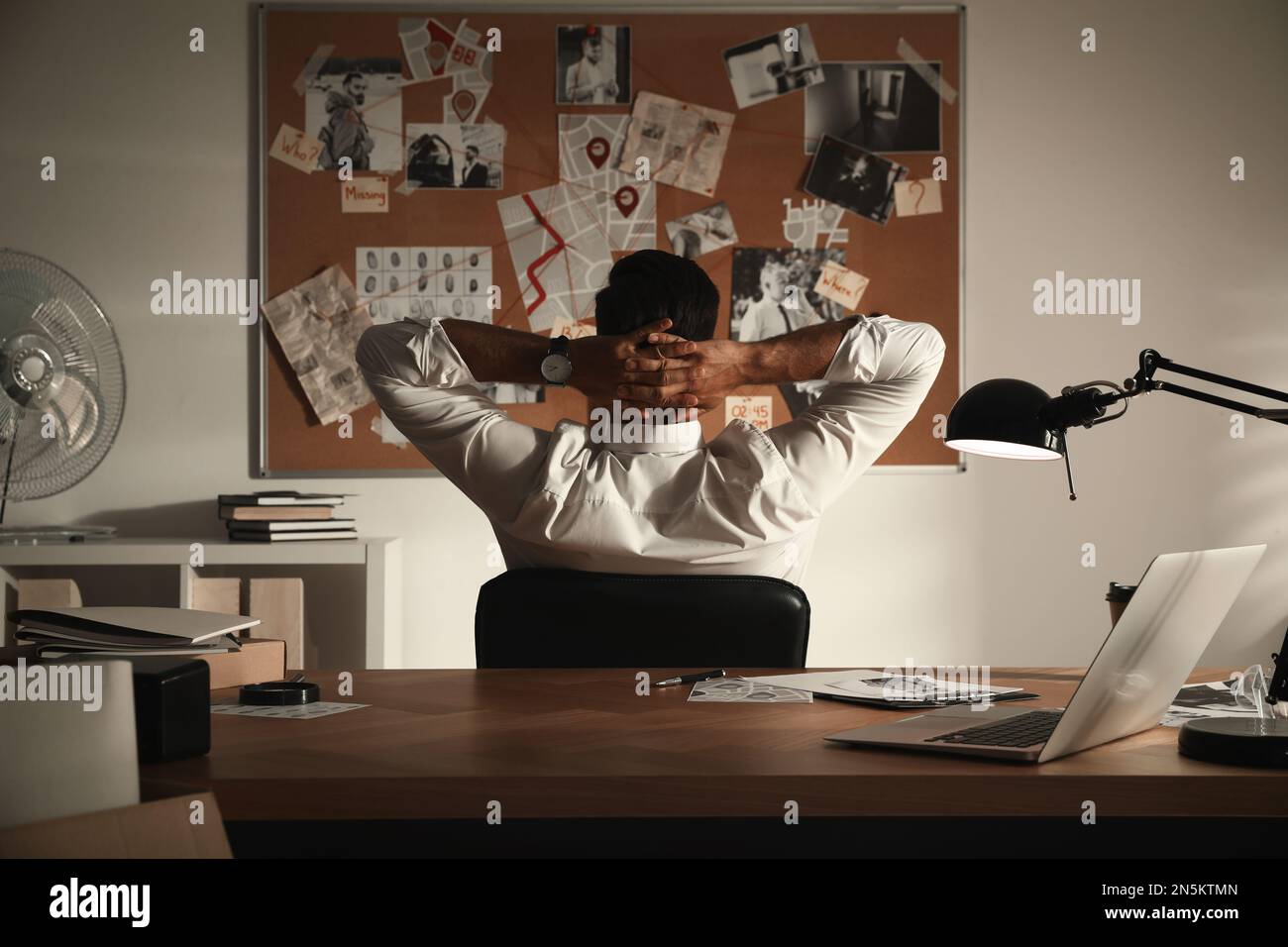 Detective looking at evidence board in office, back view Stock Photo ...