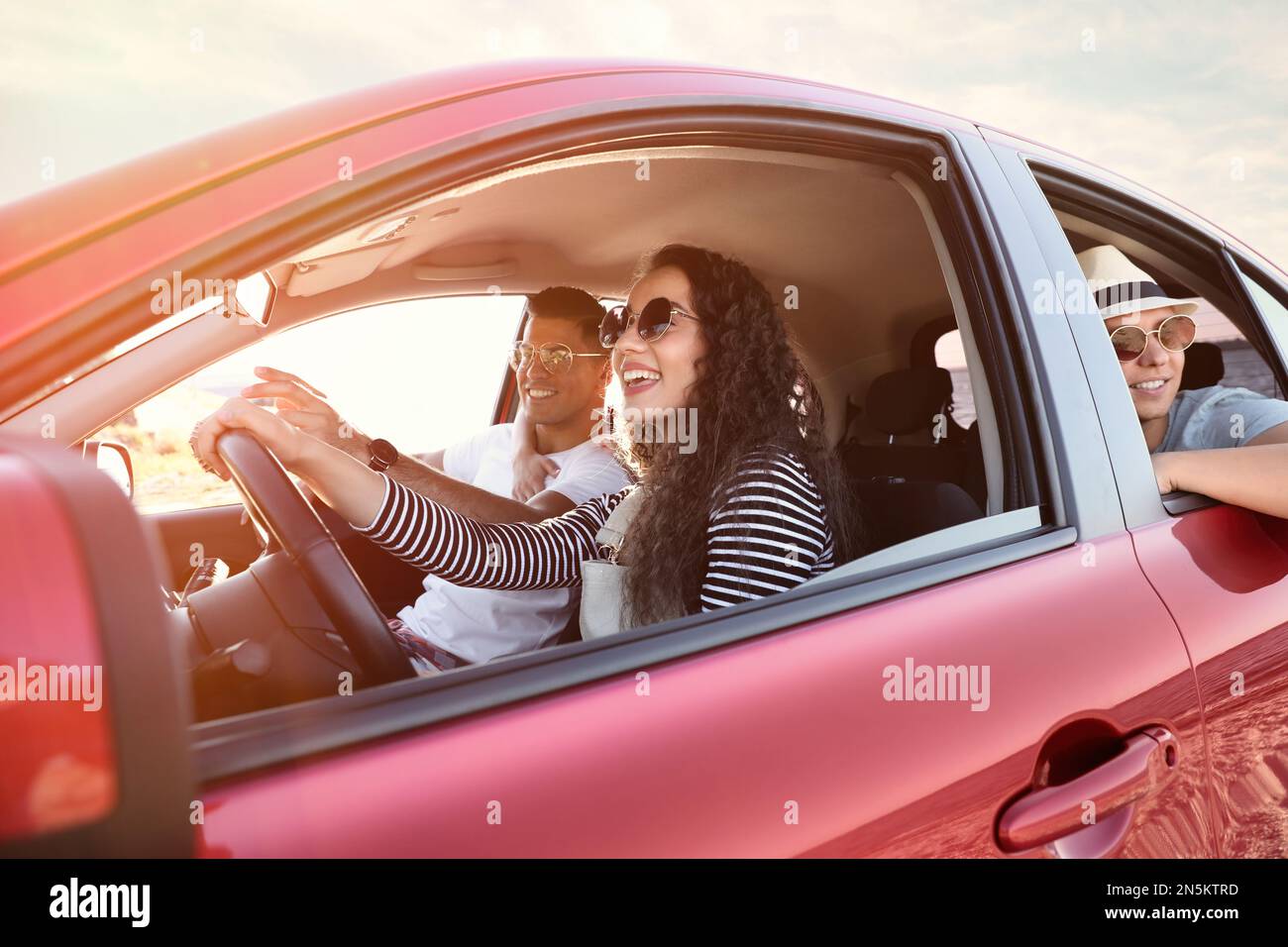 Happy friends together in car on road trip Stock Photo - Alamy