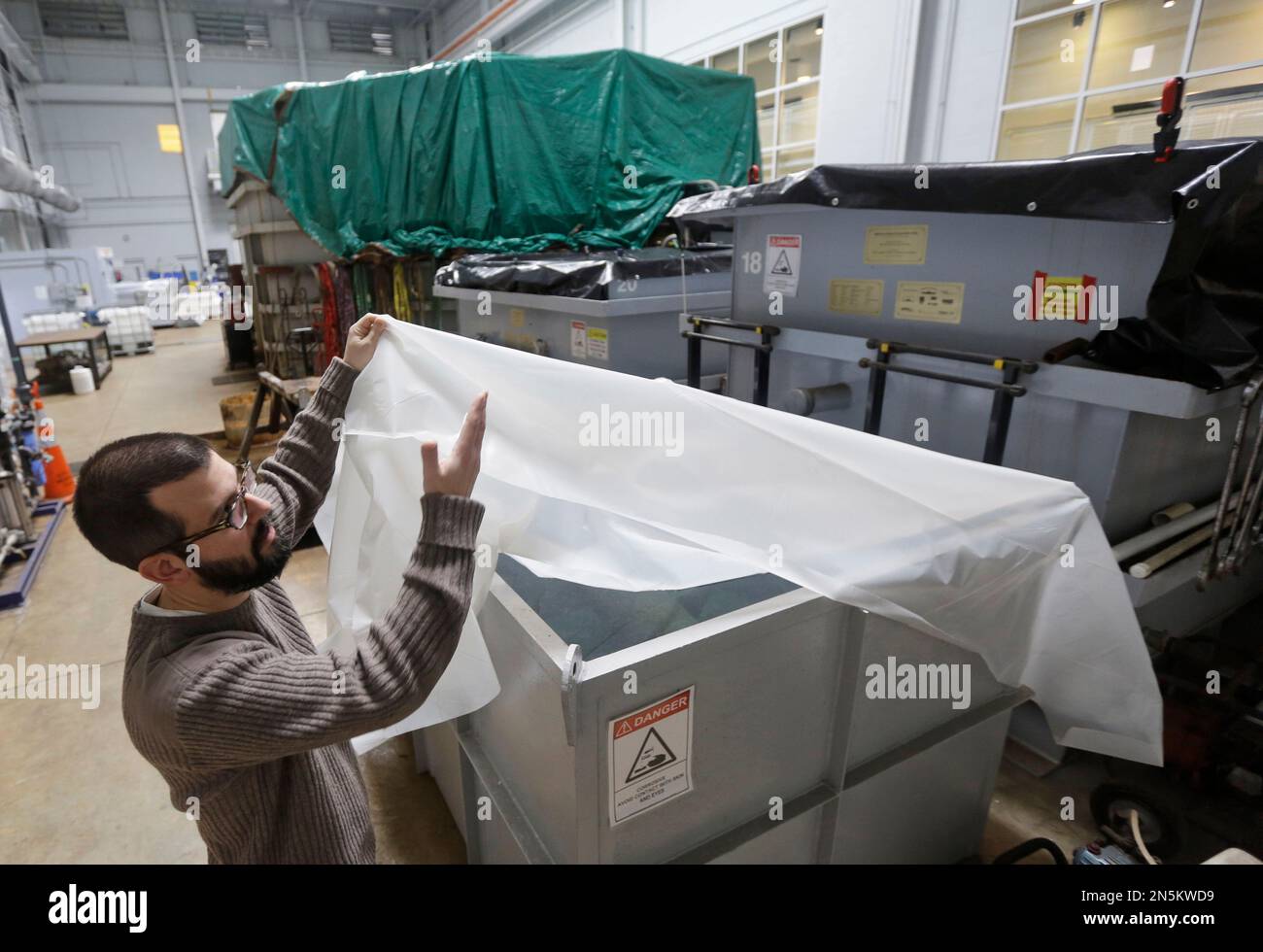 USS Monitor center director, David Krop, opens one of the closed tank ...