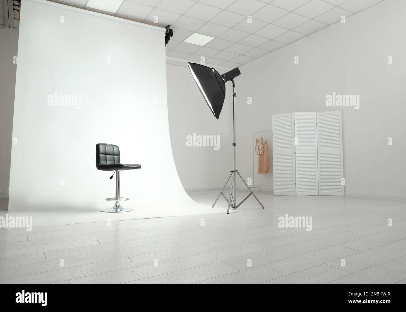 Photo studio interior with modern chair and professional lighting ...