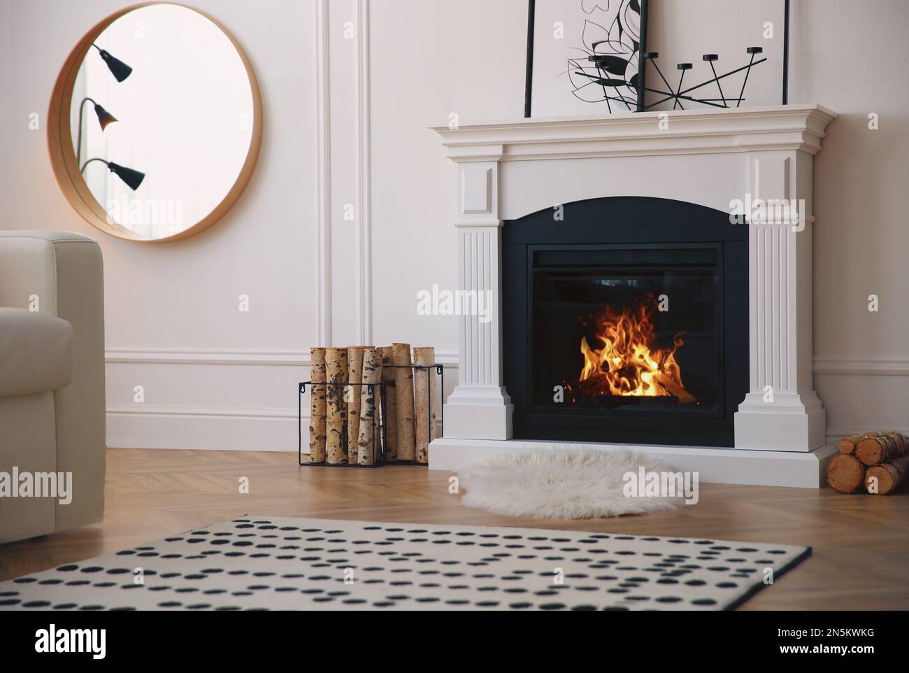 Modern fireplace with burning wood in room. Interior design Stock Photo ...