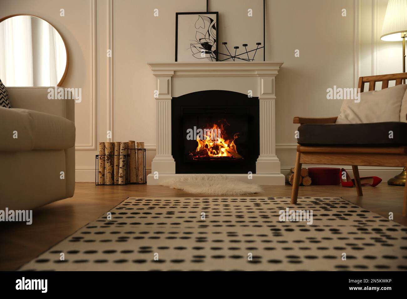 Modern fireplace with burning wood in room. Interior design Stock Photo ...