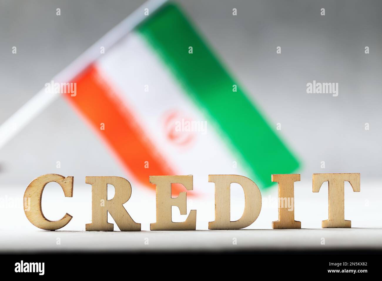 Text made of wooden letters and Iranian flag on an abstract background ...