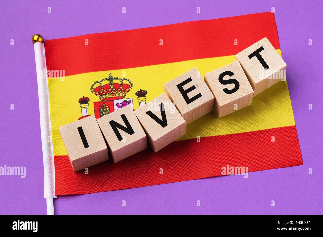 Wooden cubes with text and a flag on a colored background, a concept on ...