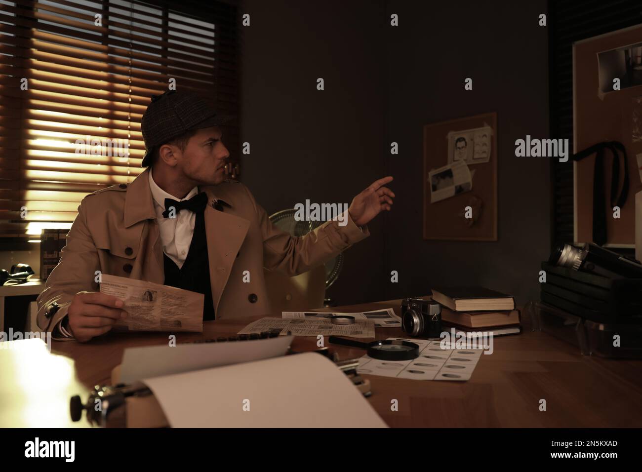 Old fashioned detective working at table in office Stock Photo - Alamy