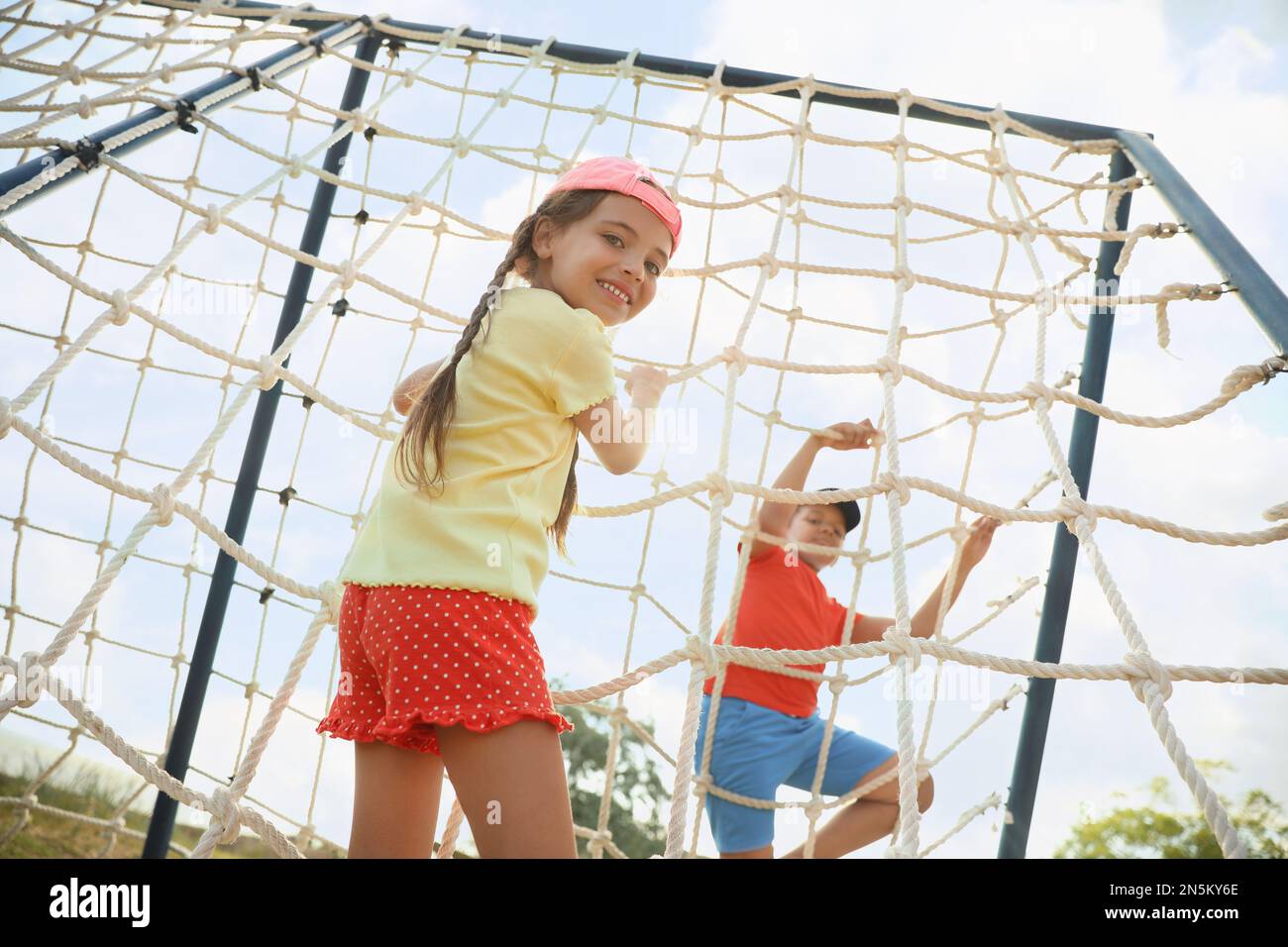 Cute children on playground rope climber outdoors. Summer camp Stock ...