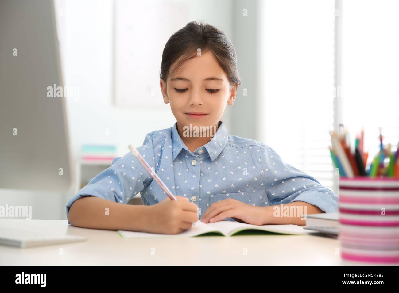 Distance learning, studying at home. Girl having online school lesson ...