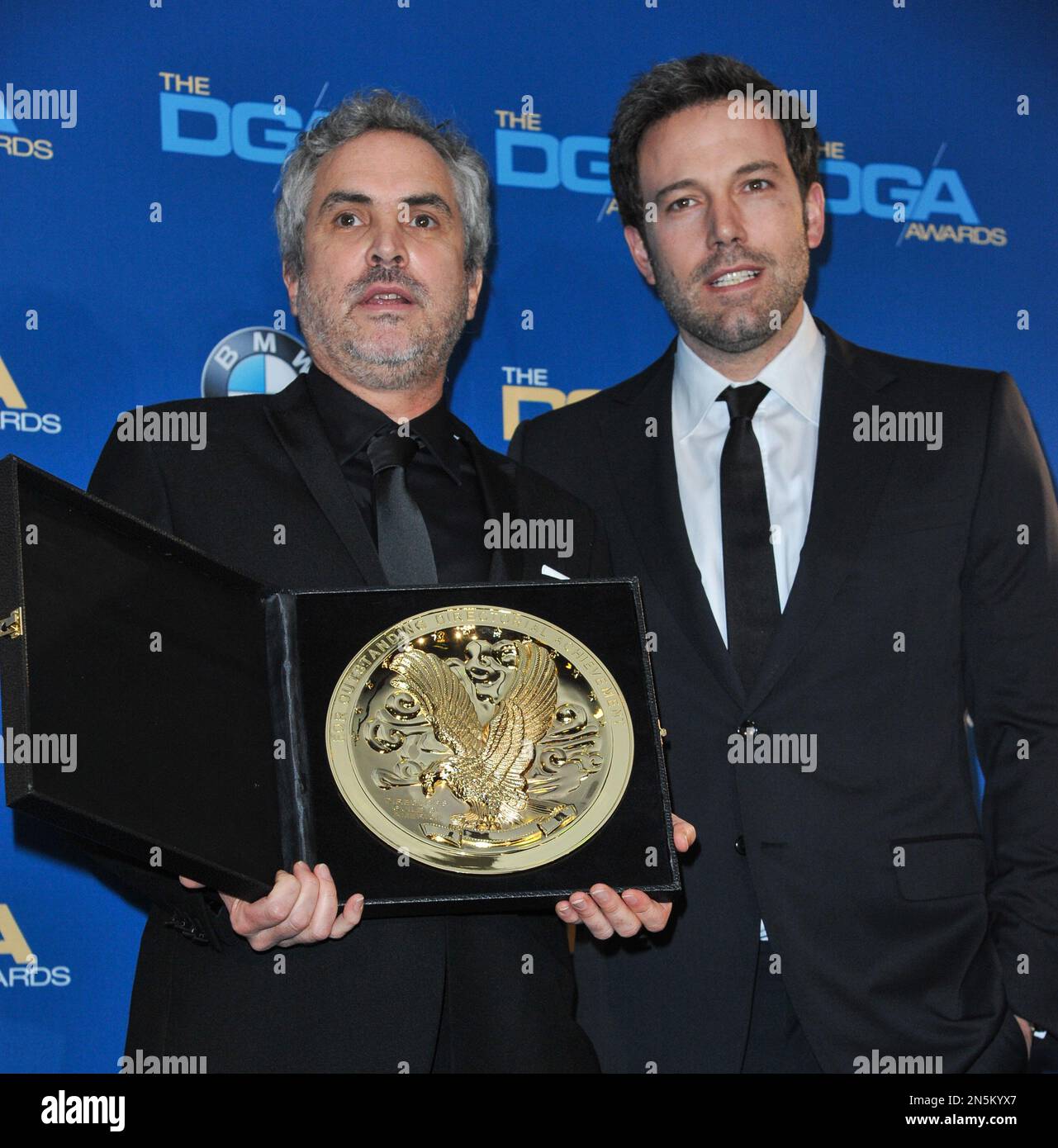 Alfonso Cuarón, left, and Ben Affleck pose in the press room of the the ...