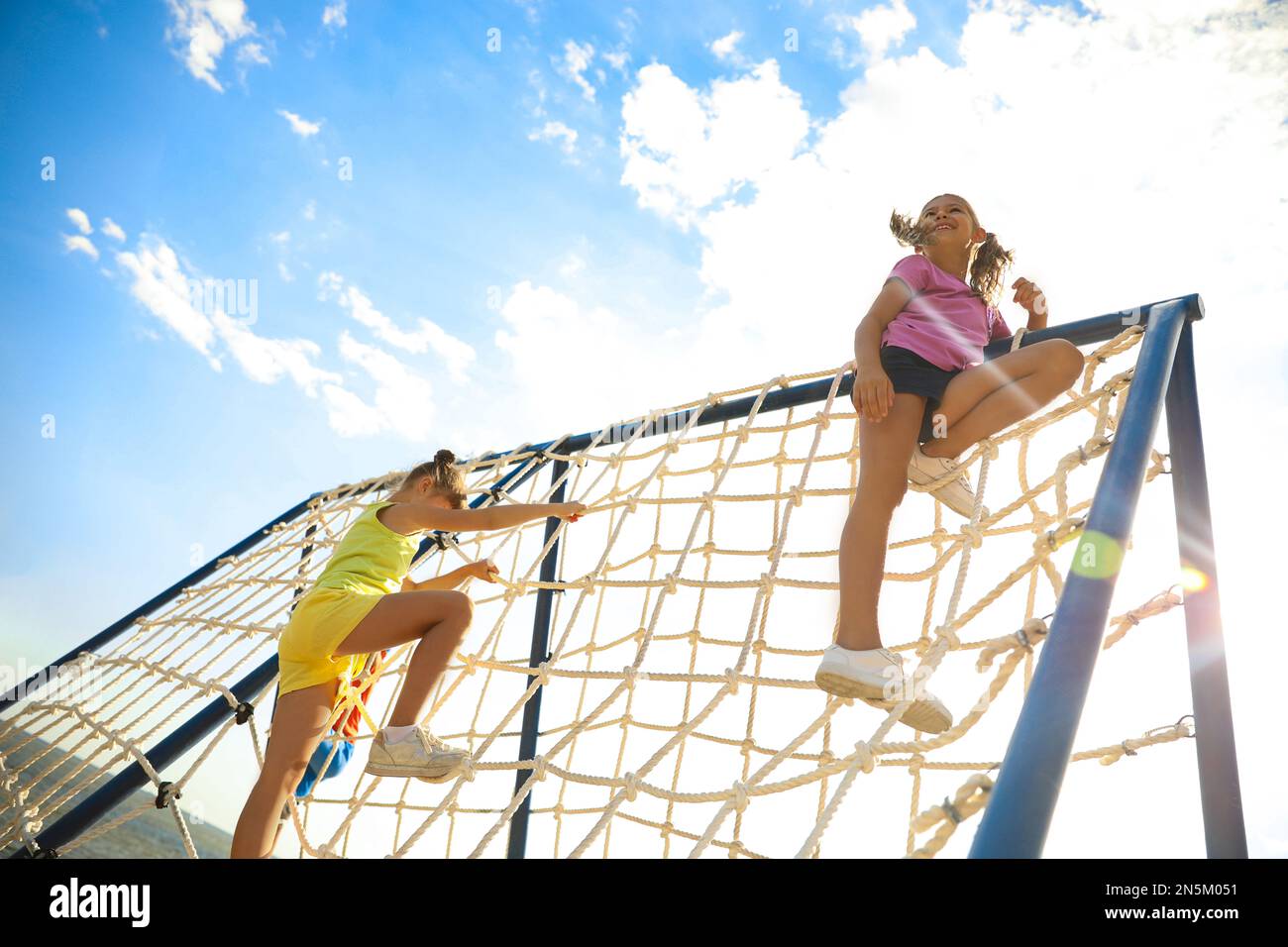 Cute children on playground rope climber outdoors. Summer camp Stock ...