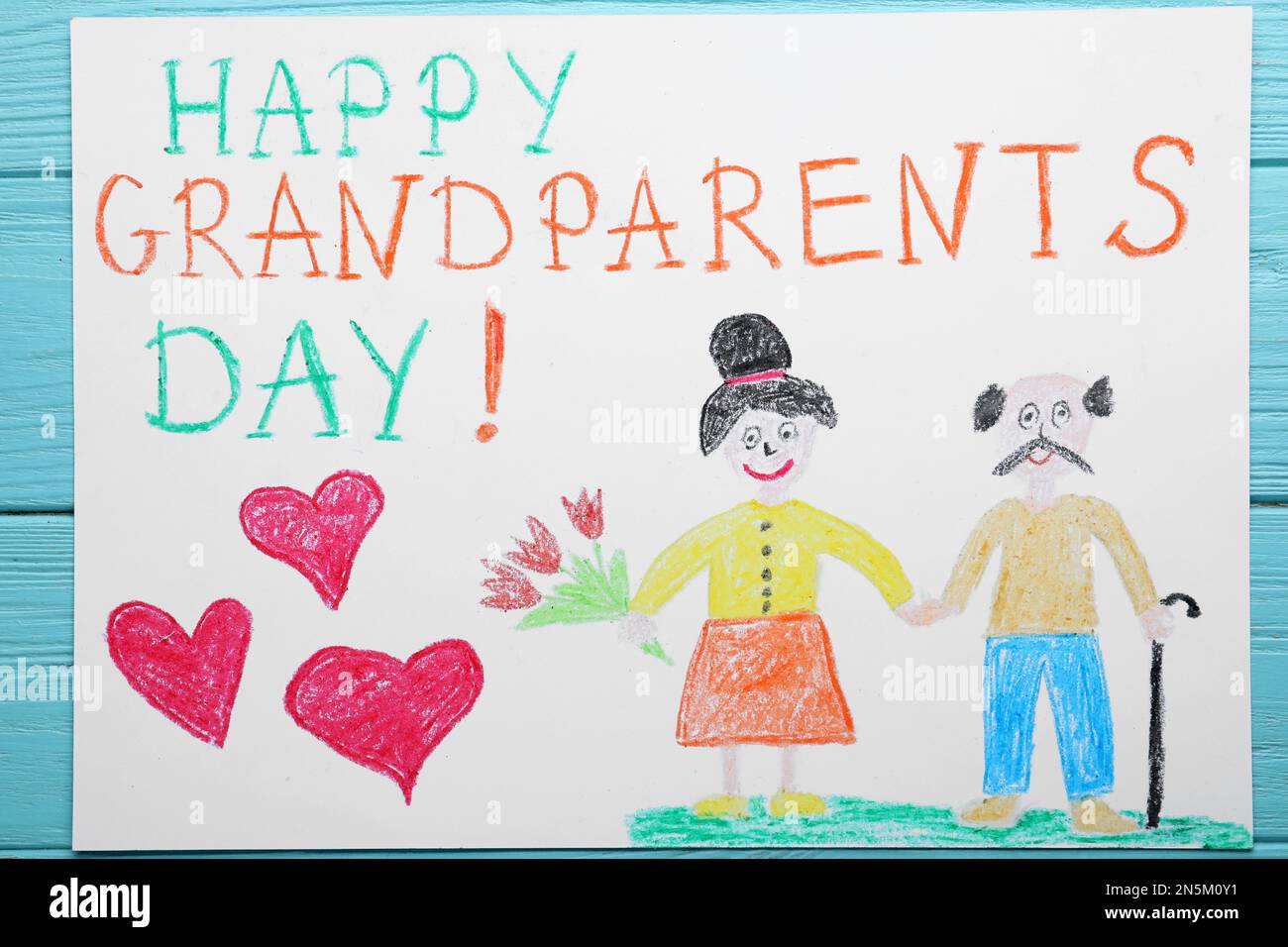 Beautiful drawing with phrase Happy Grandparents Day on blue wooden ...