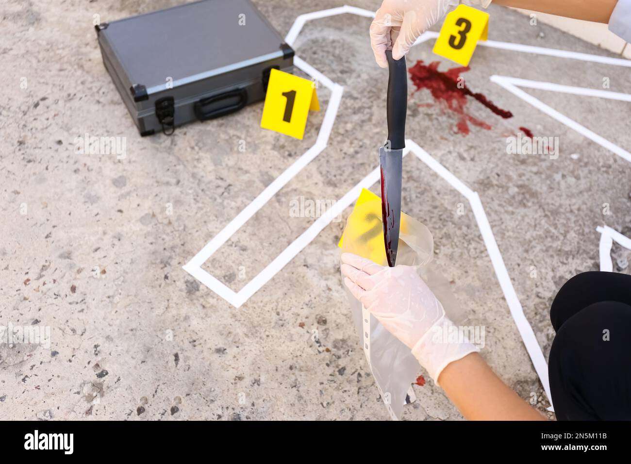 Detective collecting evidences at crime scene, closeup Stock Photo - Alamy