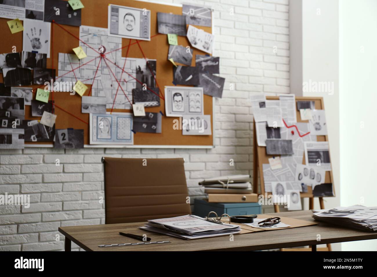Modern detective office with workplace and board Stock Photo - Alamy