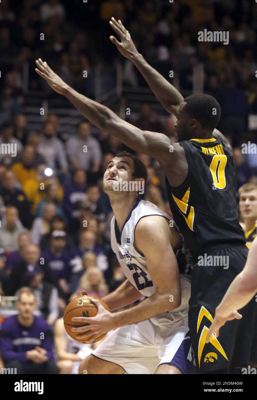 Iowa center Gabriel Olaseni, right, pressures Northwestern center Alex ...