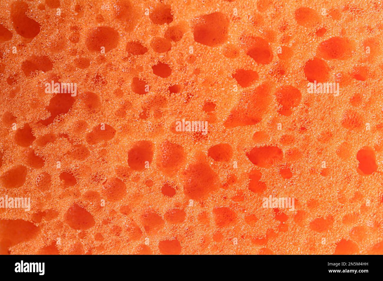 Clean orange sponge as background, top view Stock Photo - Alamy