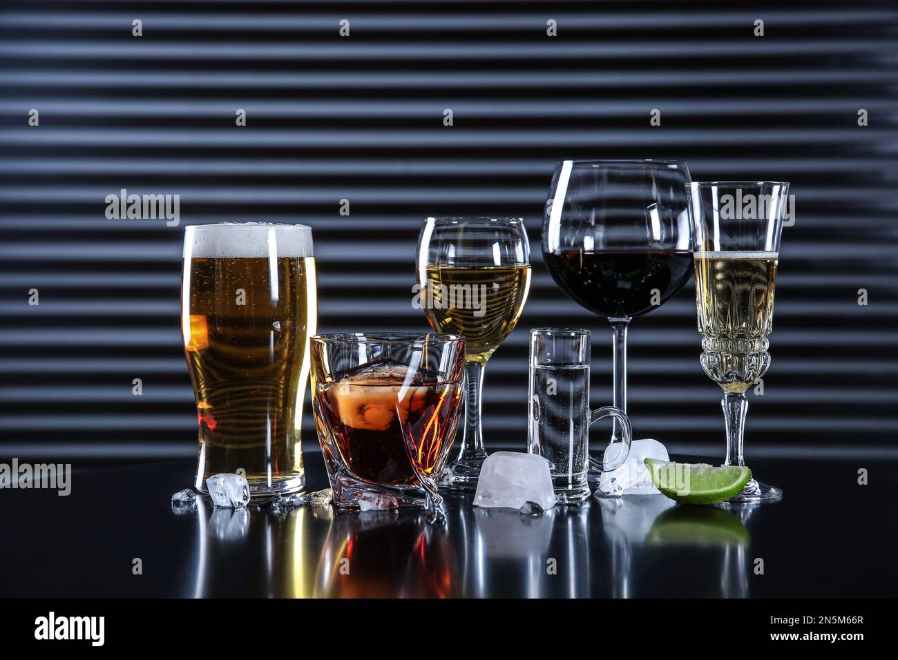 Many different alcoholic drinks on table against dark background Stock ...