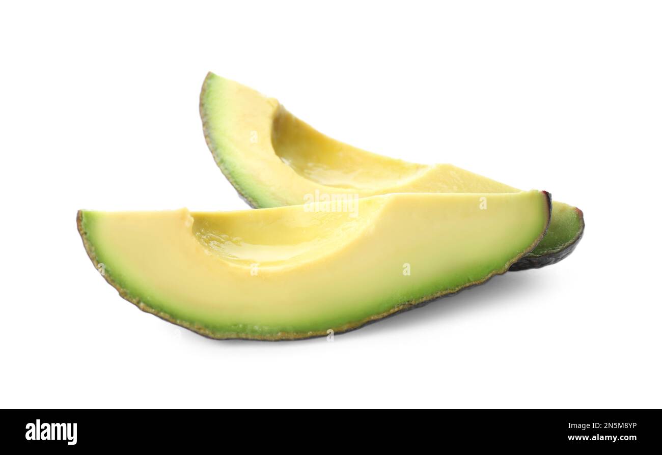 Slices of ripe avocado on white background Stock Photo - Alamy