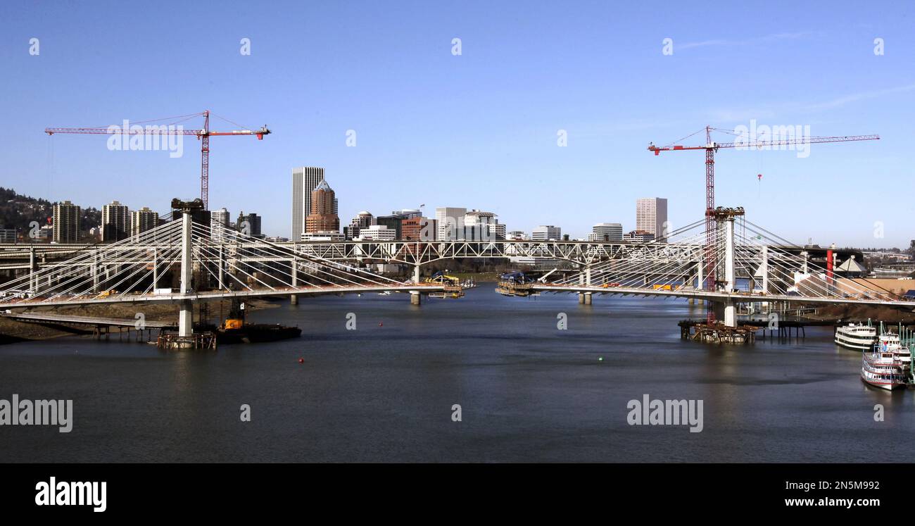 Downtown Portland is framed by cranes and uprights of the Portland ...