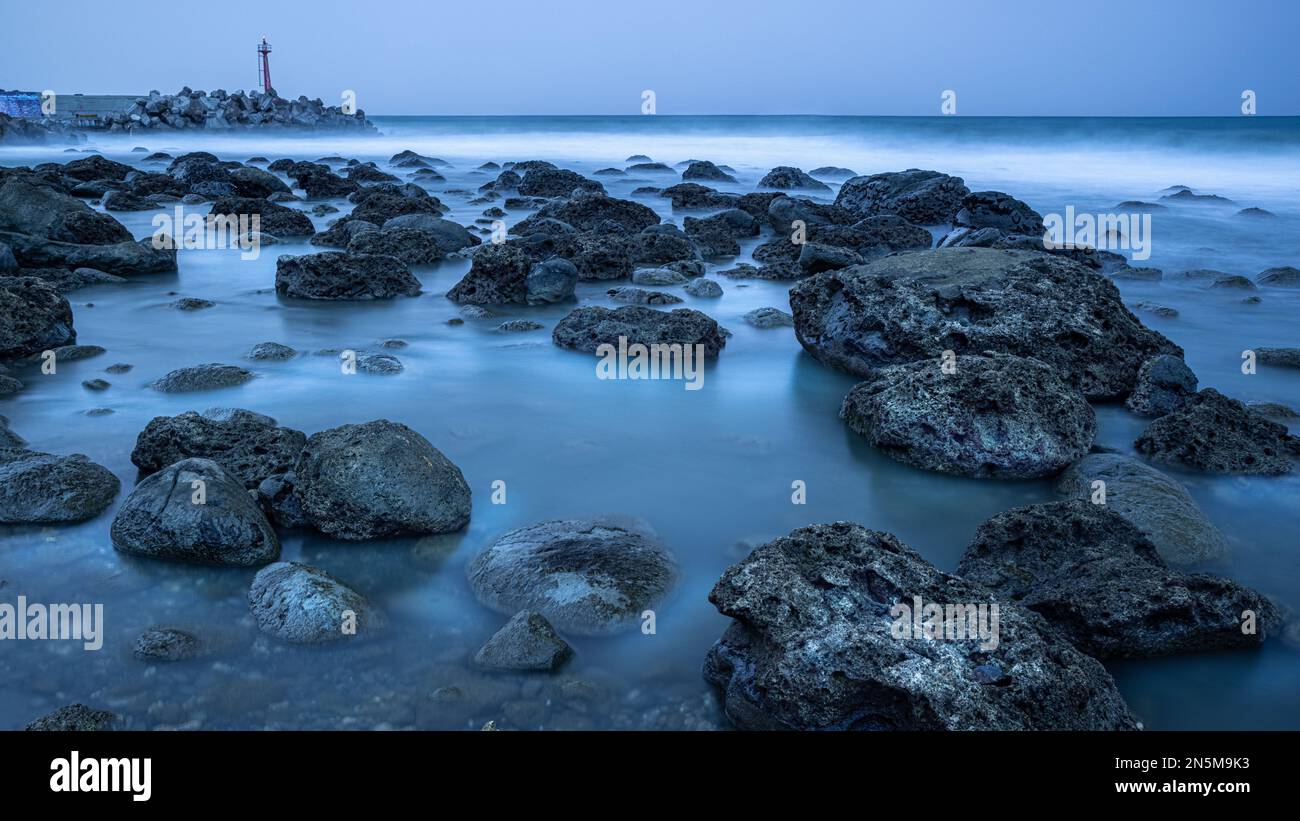 A beautiful view of splashing sea waves and rock formations in the sea ...