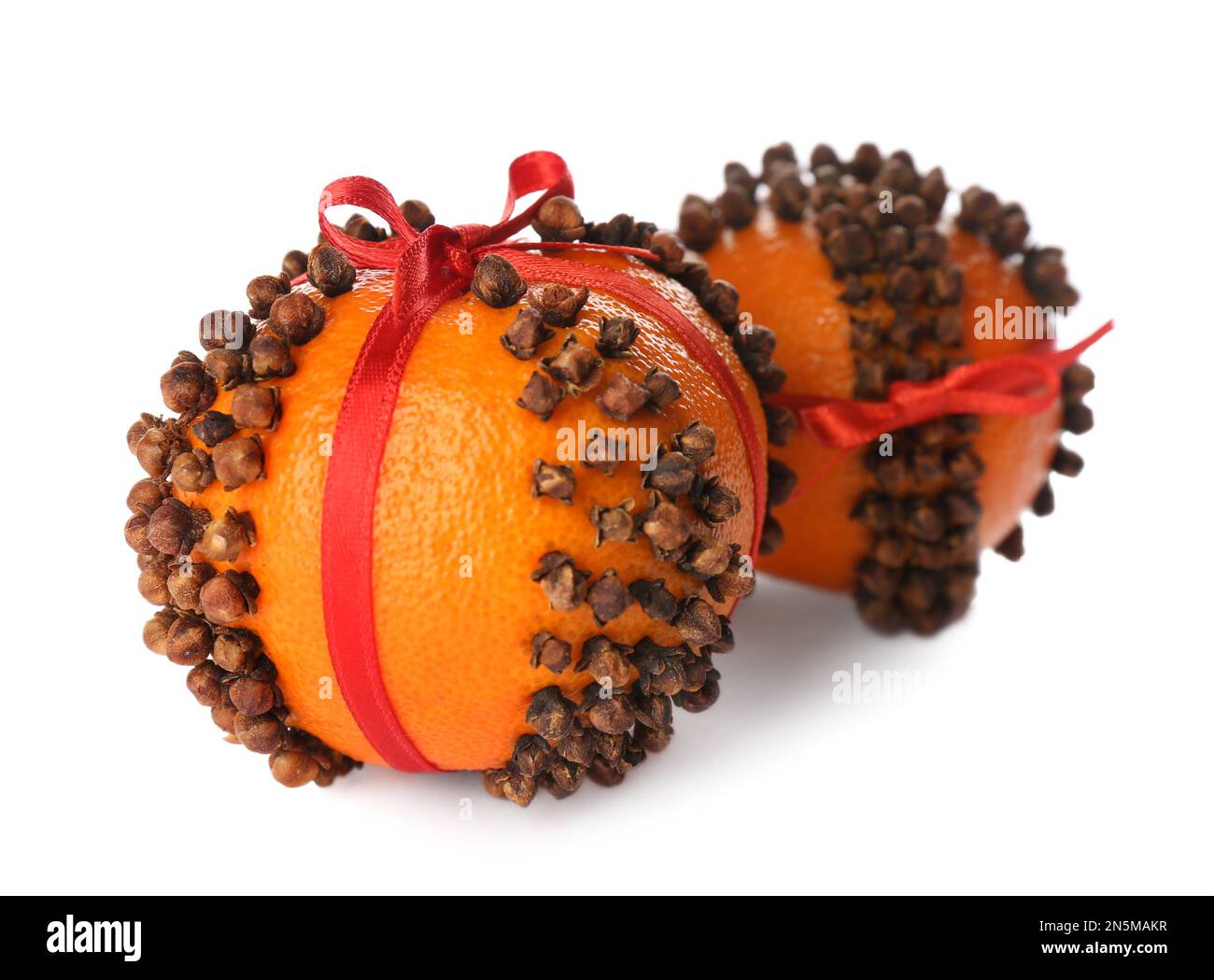 Pomander balls with red ribbons made of fresh tangerines and cloves on ...