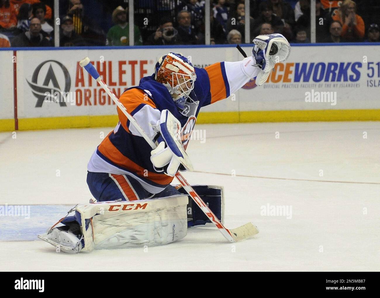 New York Islanders goalie Anders Nilsson (45) gloves a puck during an NHL hockey game against ...