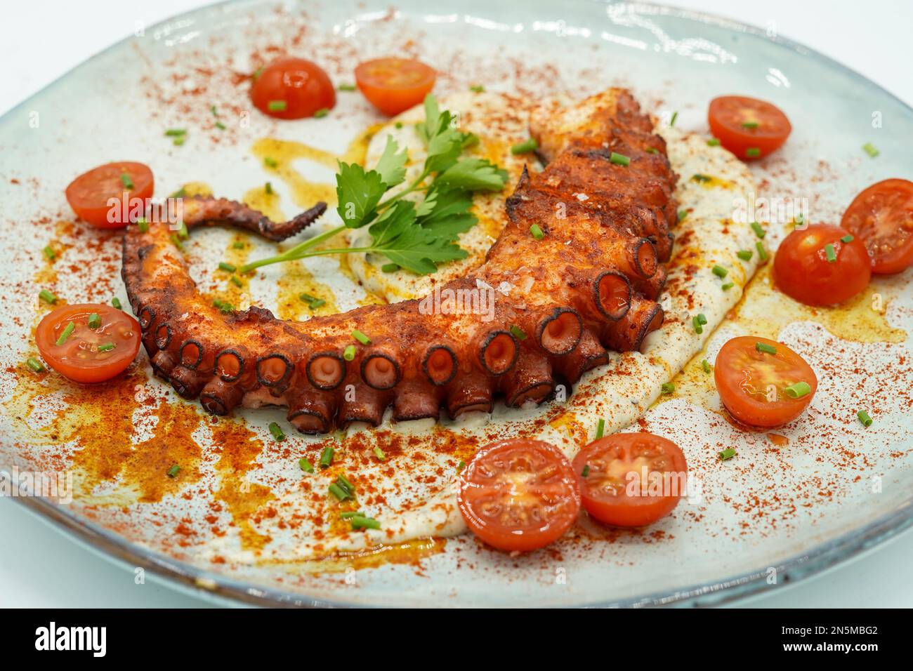 Octopus tentacle gourmet serving in a French restaurant Stock Photo - Alamy