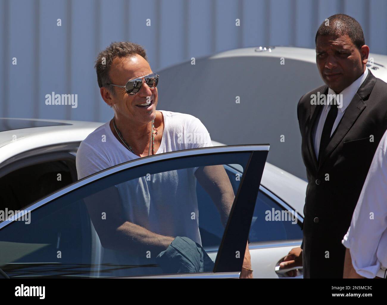 American performer Bruce Springsteen removes his jacket as he arrives ...