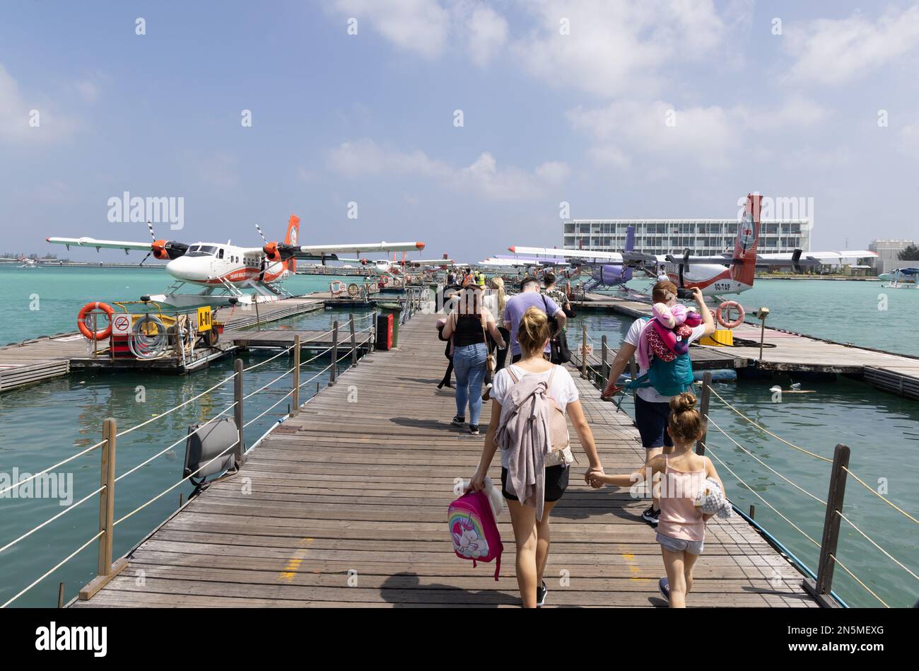 Maldives travel; passengers on the jetty boarding their seaplane, Trans ...