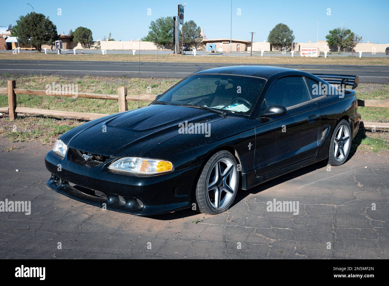 A detailed view of a parked black fourth-generation Ford Mustang Stock ...