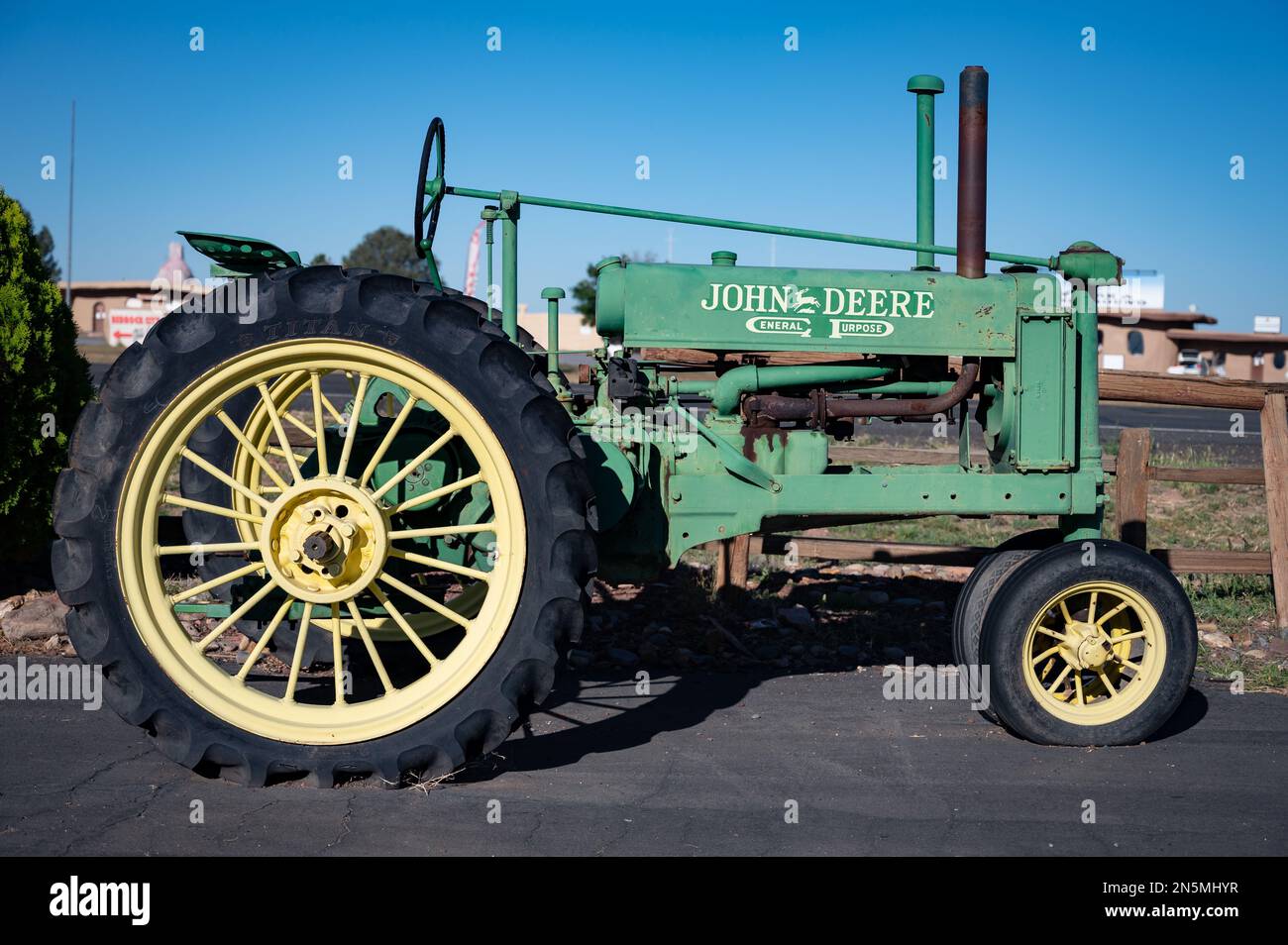 An old John Deere joint wheel tractor with green color and yellow ...