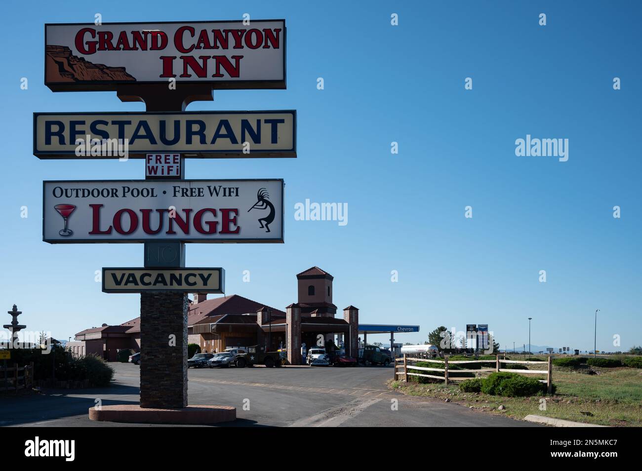 An illuminated sign during the day announcing hotels and restaurants ...