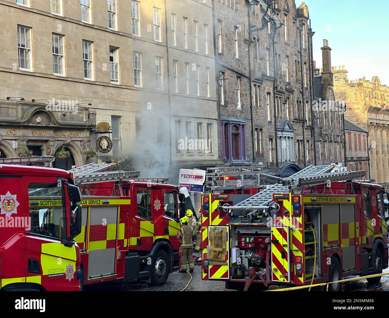 Firefighters attend to a fire on the Royal Mile in Edinburgh, Scotland ...