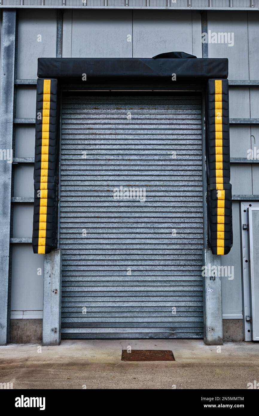 A large rollered door in a modern warehouse building Stock Photo - Alamy