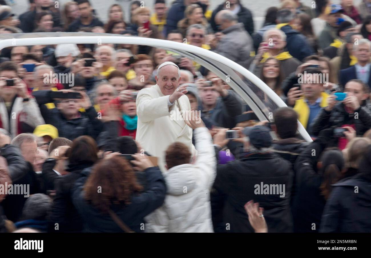Pope Francis waves to faithful from his pope-mobile as he arrives for ...