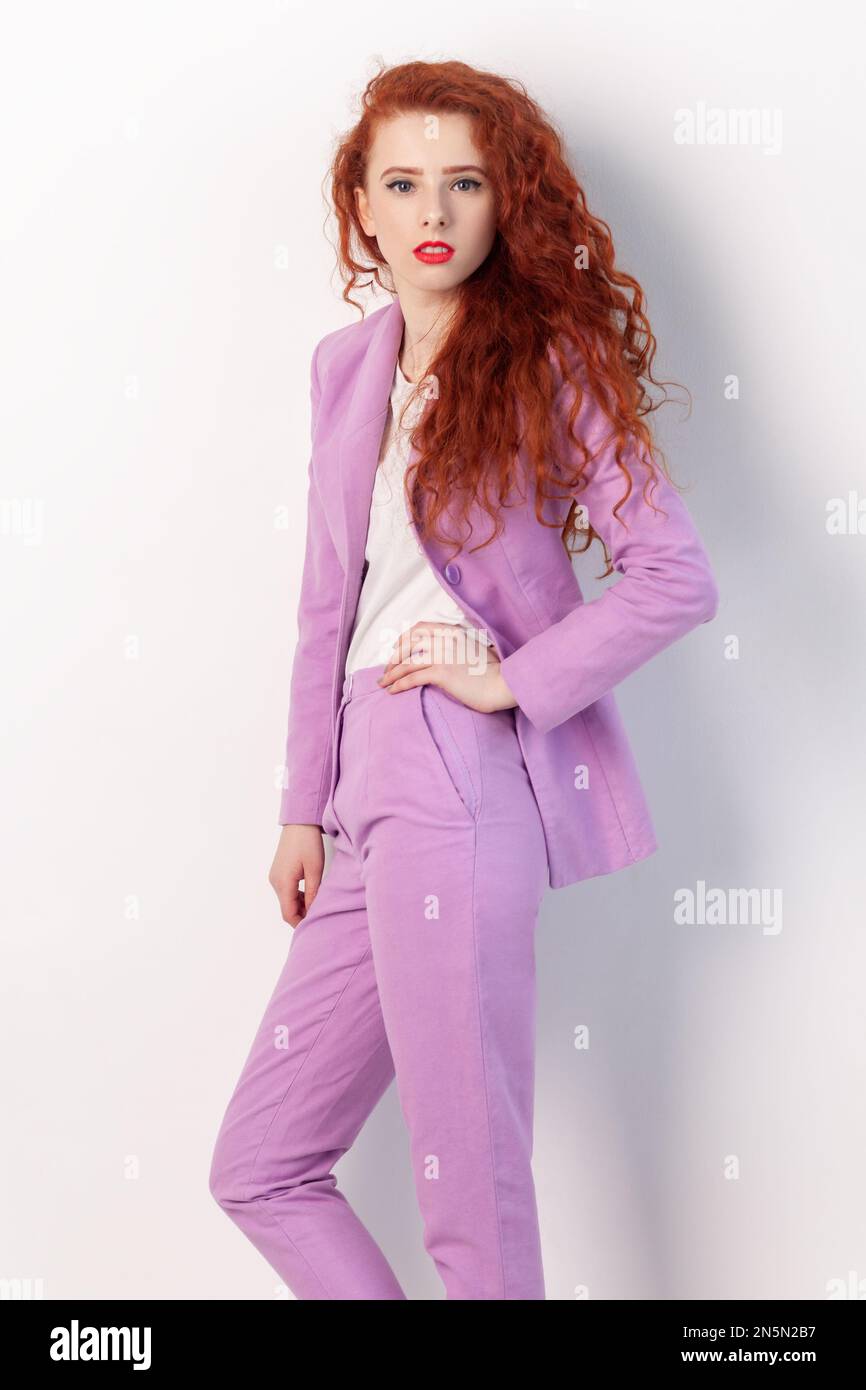 Portrait of attractive adorable confident ginger woman with curly hair ...