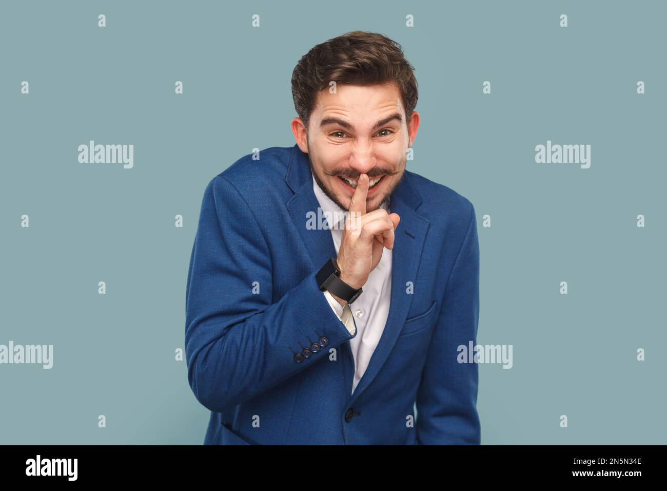 Portrait of funny smiling handsome man with mustache standing with ...