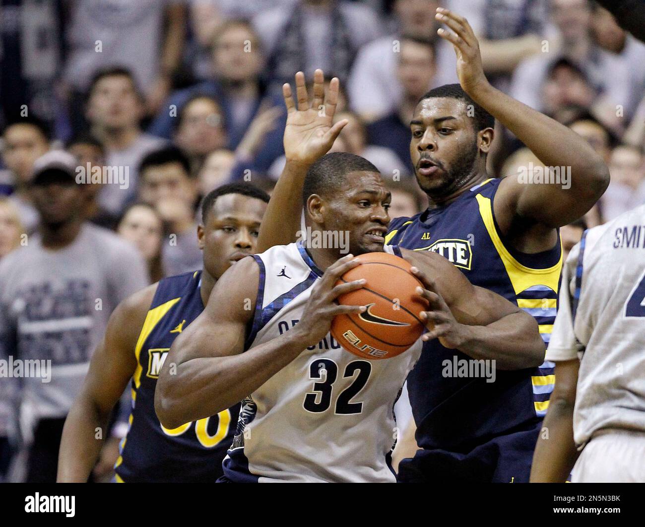 Georgetown center Moses Ayegba (32) drives against Marquette guard ...