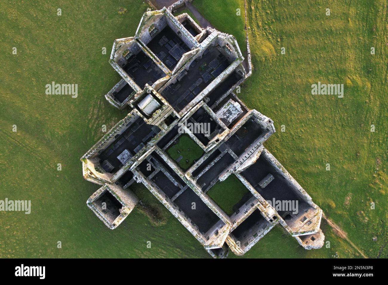 An aerial view of a large castle complex with a moat encircling the ...