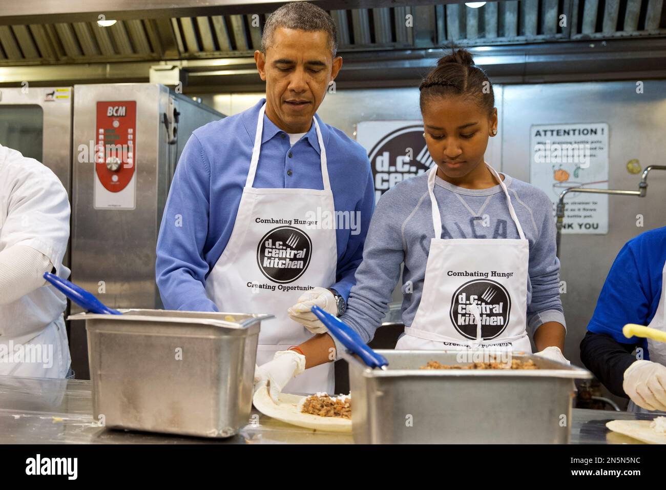 President Barack Obama and his daughter Sasha, right, make burritos at ...