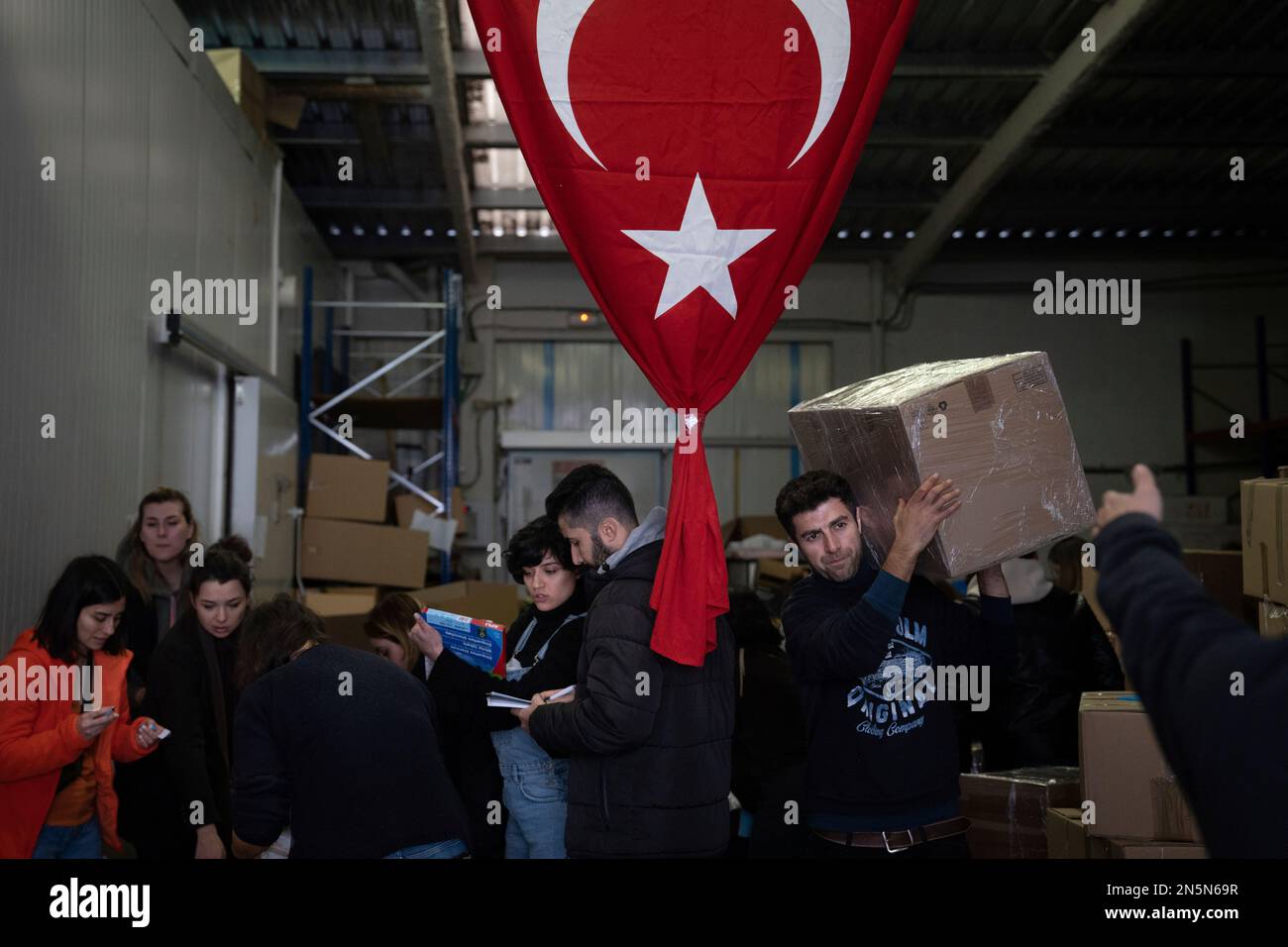 Volunteers carry boxes during the campaign to collect material to help ...