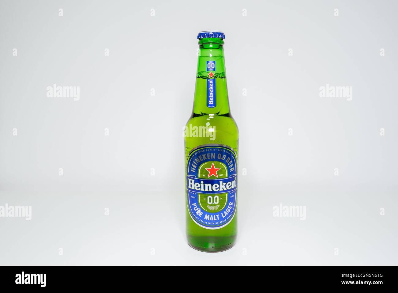 A closeup of a Heineken Beer bottle isolated against a white background ...