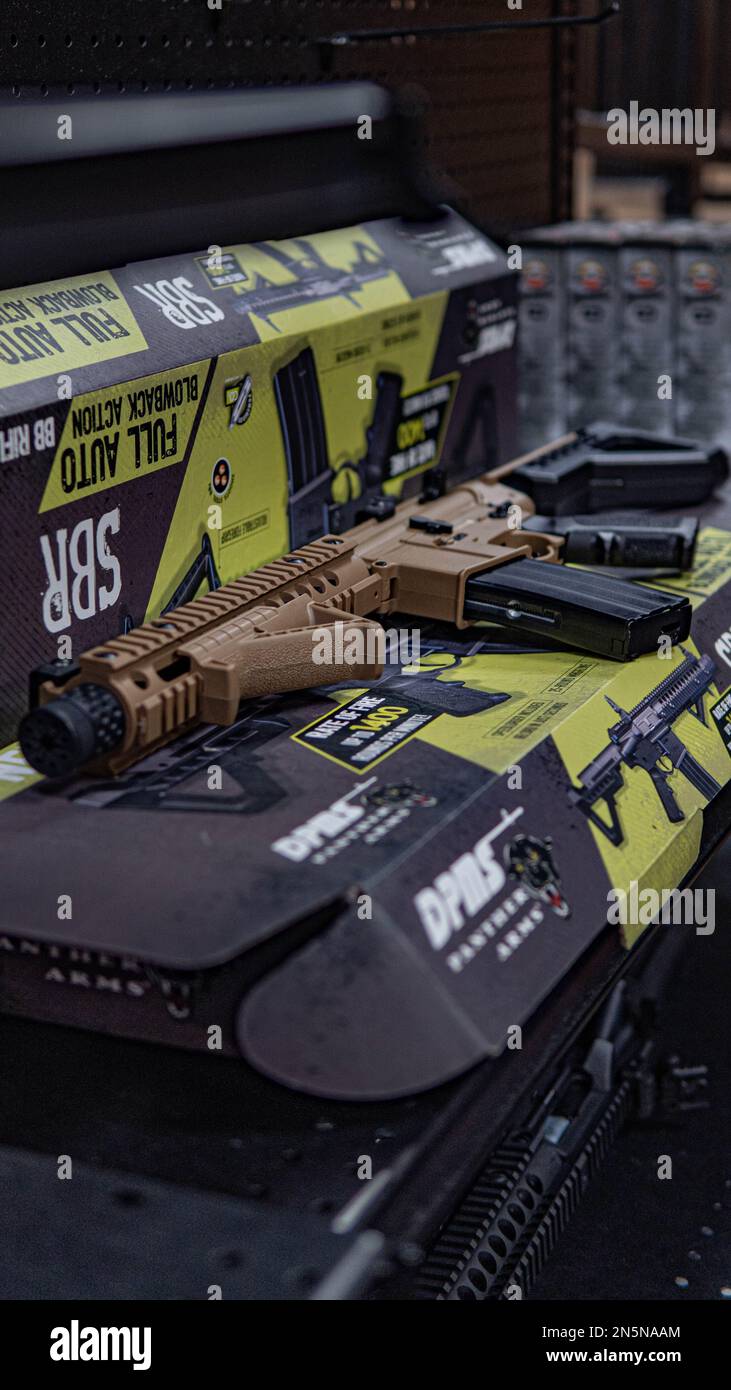A vertical shot of airsoft bb gun sitting on a box Stock Photo - Alamy