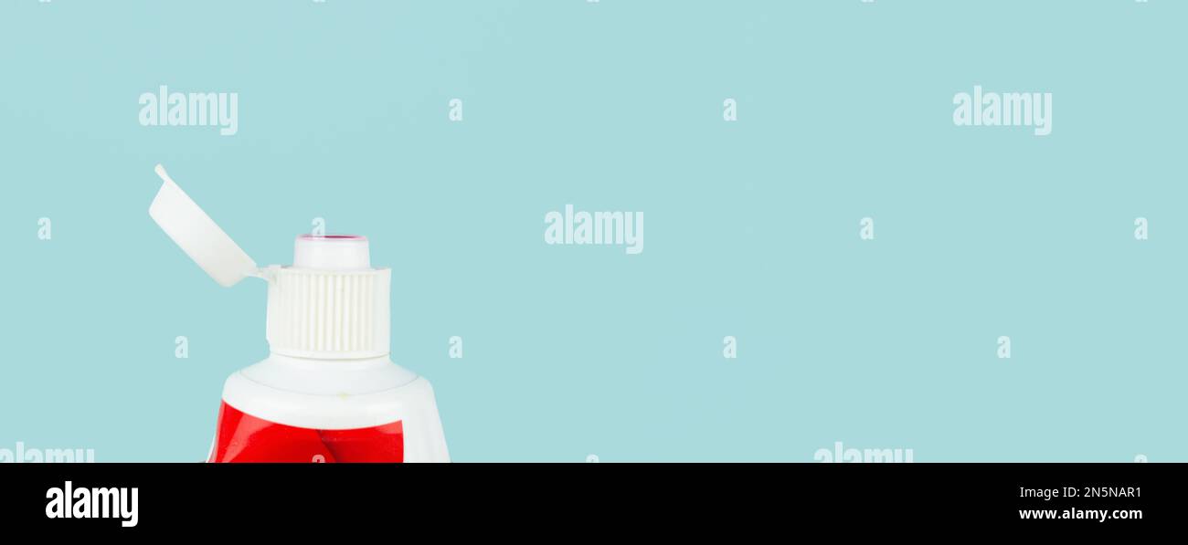 Small Red Toothpaste Tube on blue background. Means to care for the ...