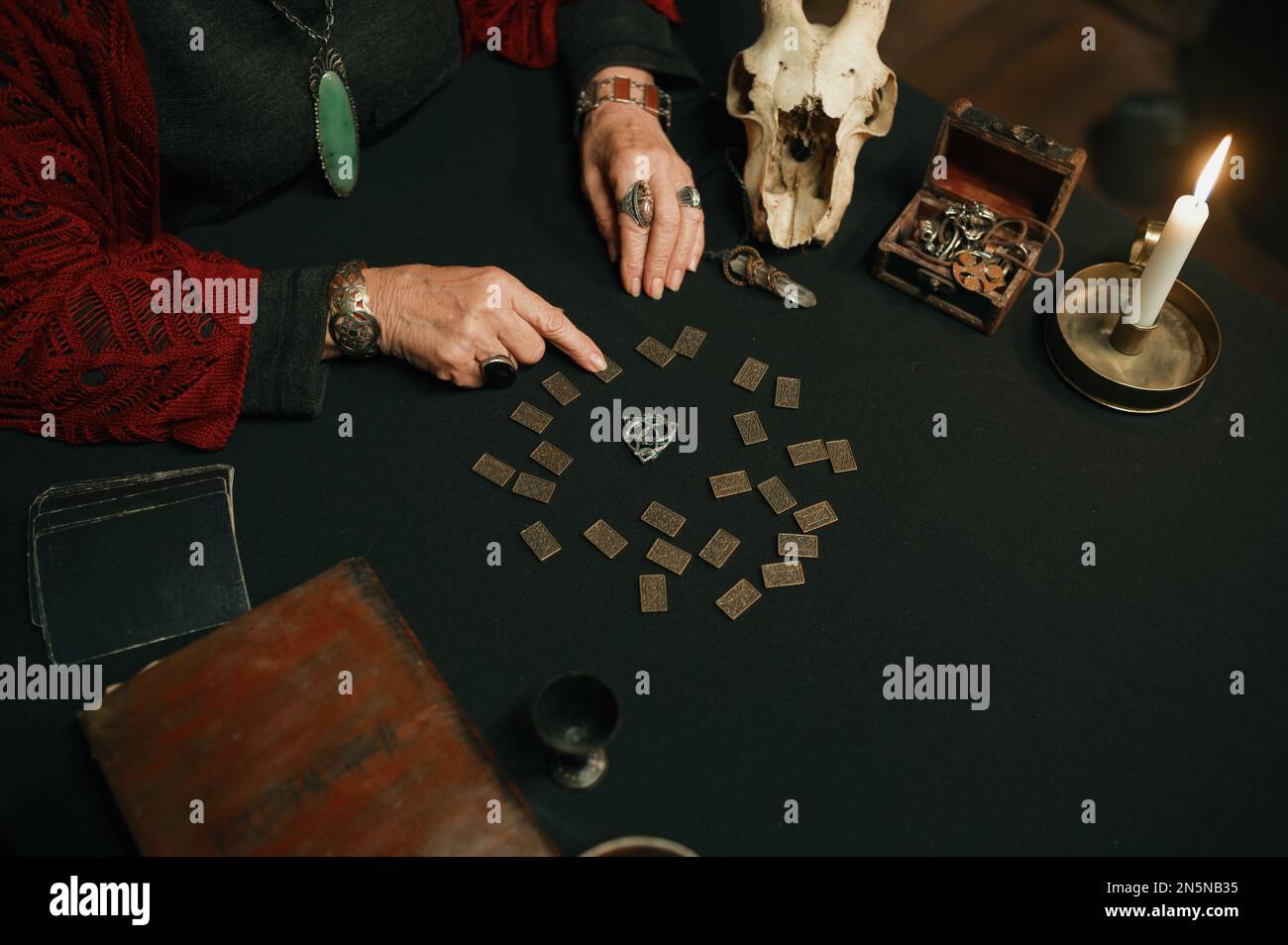 Old mature witch giving prediction using spiritual attributes closeup ...